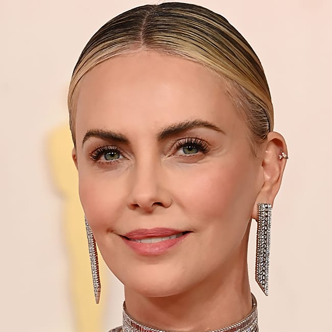 Charlize Theron Turns Heads In A Preppy Sweater & Baggy Jeans For Rare ...