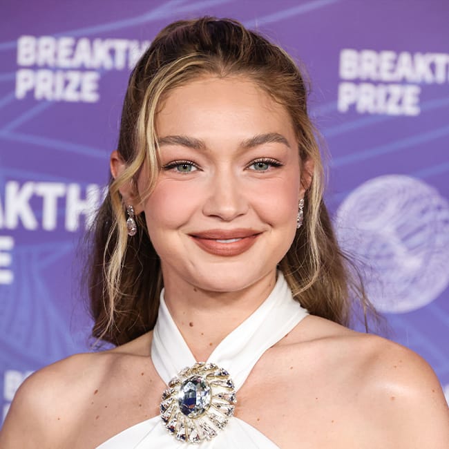 Gigi Hadid Wears The Divisive Dress-Over-Jeans Trend In Miami - SHEfinds