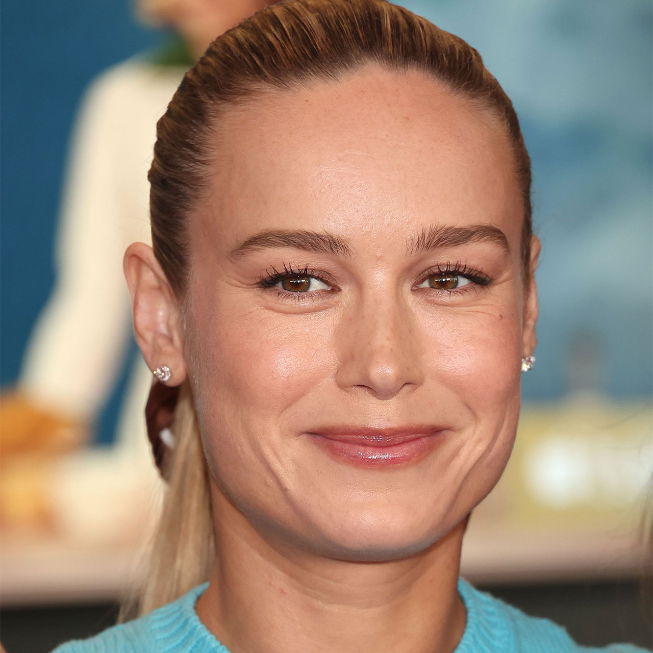 Brie Larson Is A Vision In A Baby Blue Shirt Paired With A Black Skirt ...